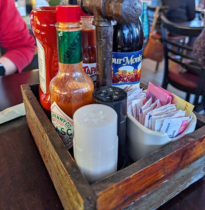 The condiment caddy: that wooden box of potential where hot sauce dreams and sweetener schemes are born.