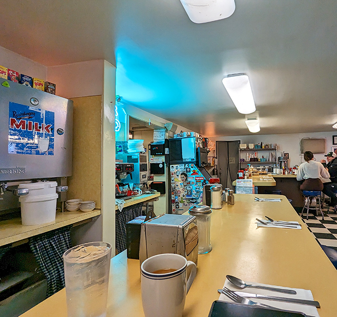 The counter where breakfast dreams come true. Classic mugs await their coffee baptism in this temple of morning rituals.