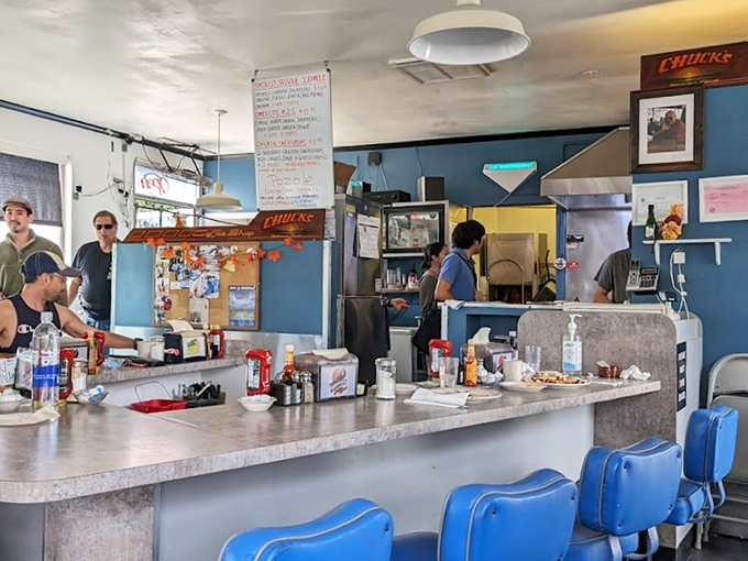 Counter seating offers front-row tickets to the breakfast theater, where culinary artistry meets friendly neighborhood charm.