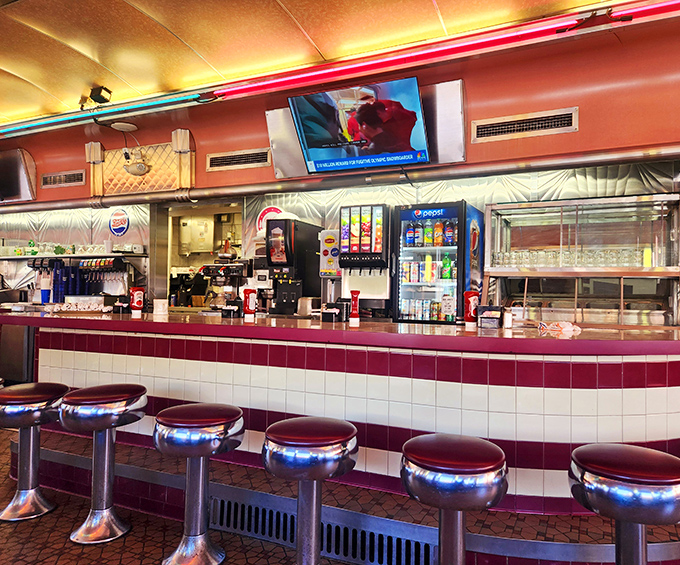 The counter at Neptune offers front-row seats to the ballet of short-order cooking, where skilled hands move with practiced precision.