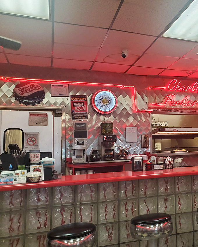 The counter seating offers front-row tickets to the breakfast show, where neon signs cast that perfect nostalgic glow over your morning coffee.