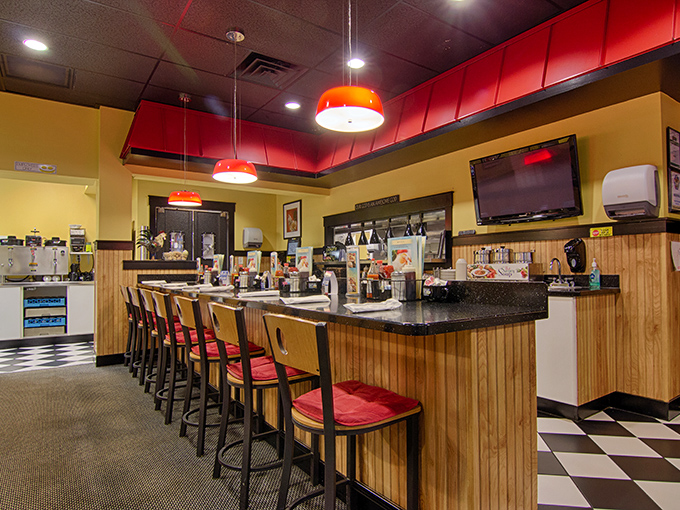 Counter seating: where breakfast becomes theater and you get front-row tickets to the morning show. Red accents add that diner-with-class touch.