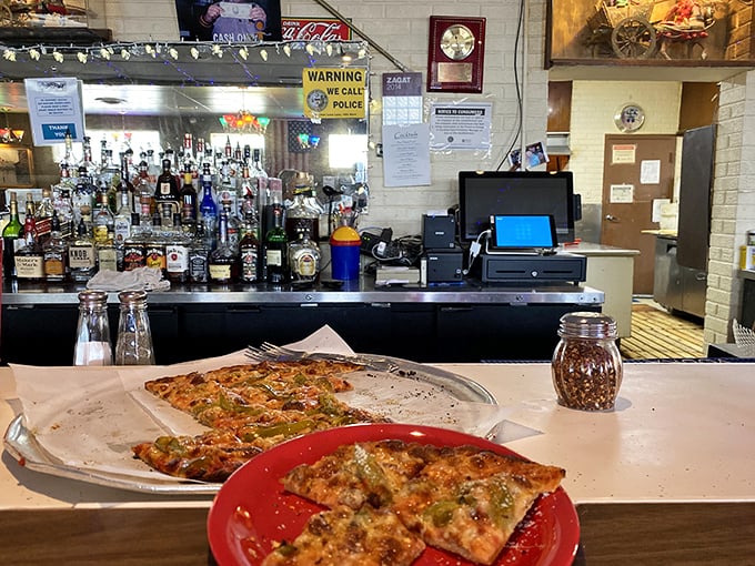 The bar view offers a front-row seat to pizza paradise, where Old Style flows as freely as the conversation.
