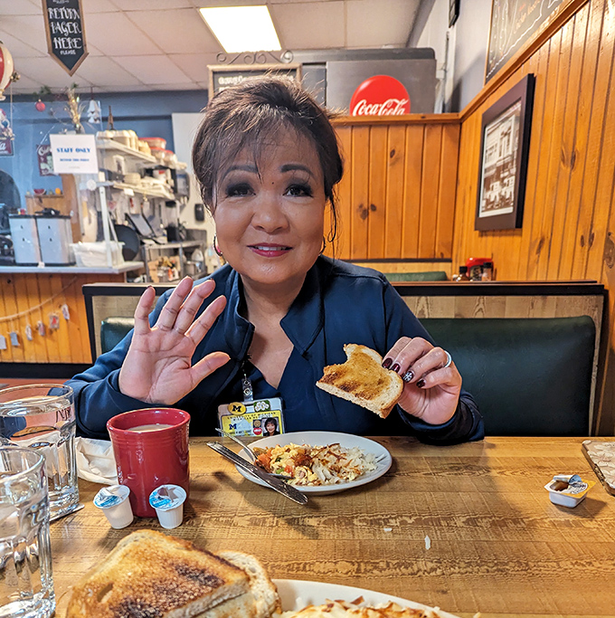 The universal language of good food brings smiles to diners' faces. That toast looks like it's about to change someone's morning for the better.