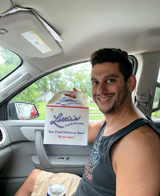 The universal expression of takeout triumph. That box contains what locals know is Delaware's edible treasure&mdash;fried chicken worth the drive from anywhere.