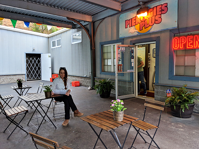 The outdoor seating area offers a moment of calm before the flavor storm. Simple metal tables become the stage for some serious Eastern European culinary theater.