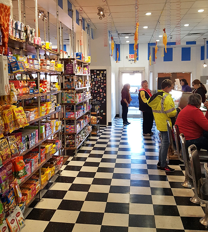 Customers of all ages gather at the counter, united by the universal language of "just one more piece won't hurt."