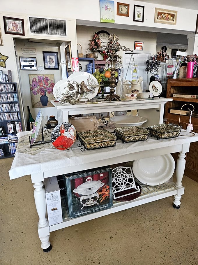 White farmhouse table displaying treasures that survived decades of family dinners. Those wire baskets probably held grandma's famous dinner rolls once upon a time.