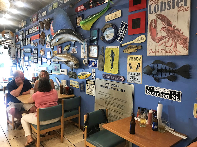 Blue walls adorned with fish trophies and nautical signs create the perfect seafood shrine. It's like dining inside a fisherman's most cherished memories.
