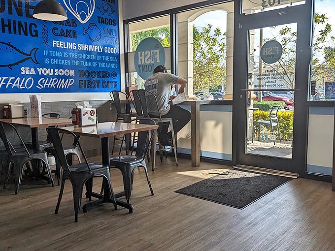Sunlight streams through windows illuminating wooden tables where seafood memories are made. The door practically begs you to bring friends next time.
