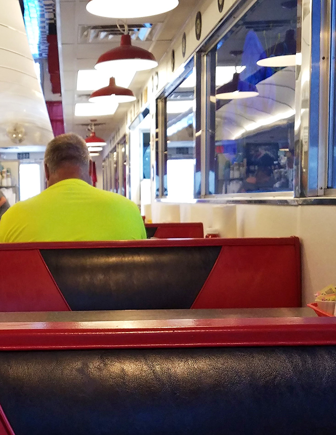 Classic diner seating that whispers, "Stay awhile," with red vinyl that's seen more stories than a small-town librarian.