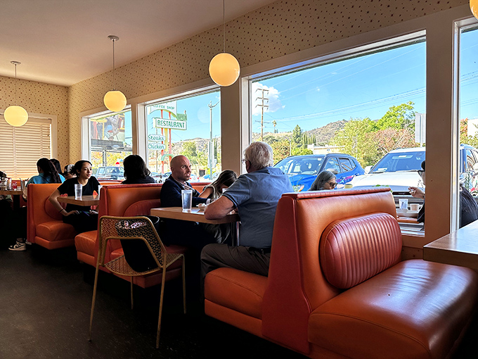 Where strangers become neighbors over coffee and eggs. The sunlight streaming through those windows turns breakfast into theater.