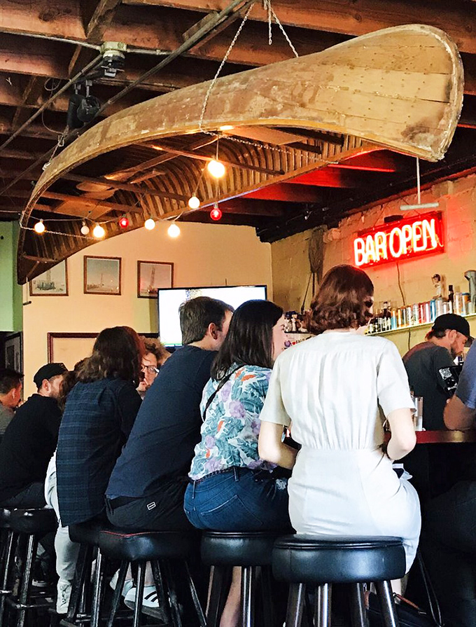 The canoe hanging from the ceiling might seem odd elsewhere, but here it's just another conversation piece in a room designed for communal enjoyment.