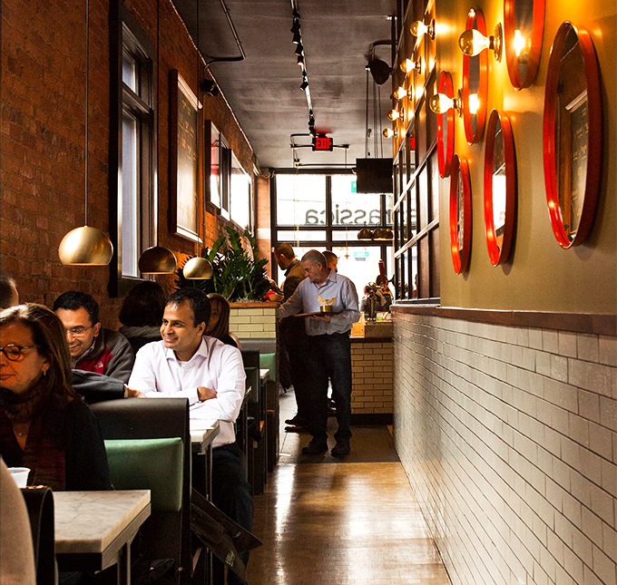 The narrow dining space buzzes with the energy of happy eaters. Notice how nobody's looking at their phones? That's the power of good food.