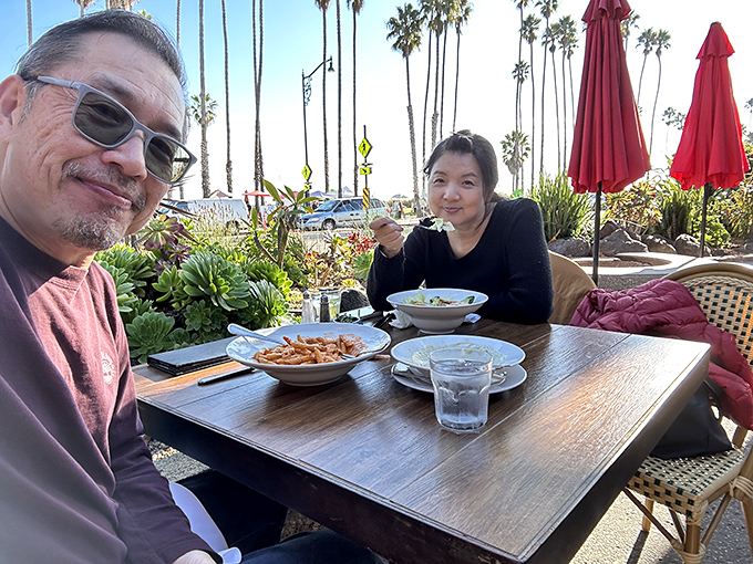 Outdoor dining with palm trees swaying overhead – the quintessential California experience that makes even locals feel like they're on vacation.