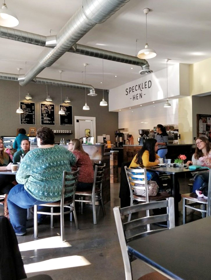 10. diners
The true measure of a great café: happy diners lost in conversation, bathed in natural light under the watchful eye of the Speckled Hen sign.