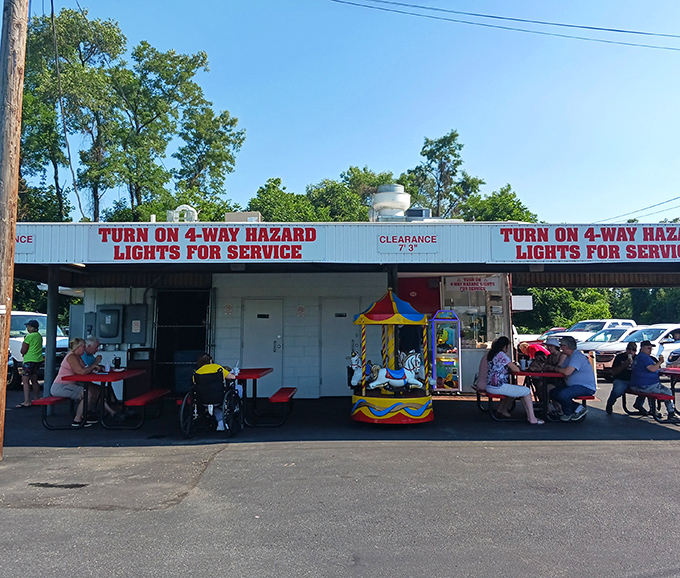 Where strangers become neighbors over shared meals. The sign says "Turn on 4-way hazard lights for service" &ndash; a charming ritual from simpler times.
