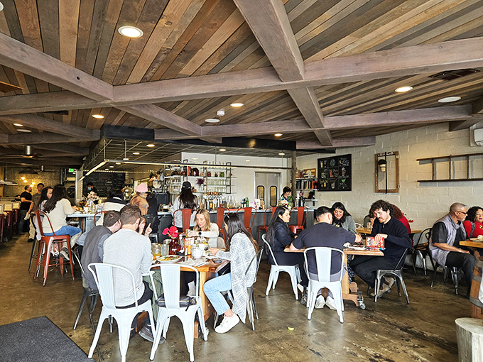 A bustling dining room where strangers become temporary neighbors, united by the universal language of "Oh my god, you have to try this."