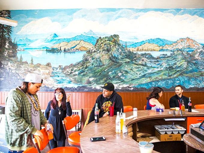 Locals gather under the panoramic mural, proving that great food creates community in a way that no amount of trendy d&eacute;cor ever could.