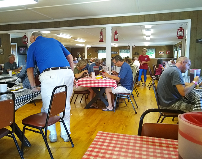 A dining room filled with people who understand that great barbecue is worth sitting up straight for. The serious business of enjoyment is underway.