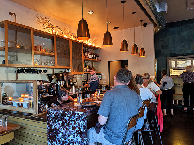 The bar seating offers front-row tickets to the culinary show. Watch the bartenders craft drinks with the precision of Swiss watchmakers.