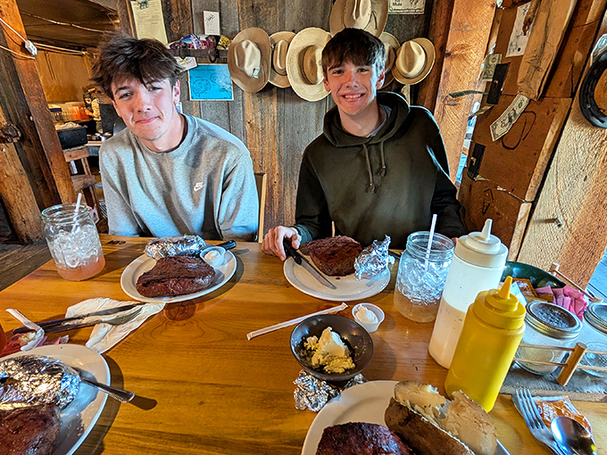 The universal expression of "How are we supposed to finish all this?" Two young diners contemplate the mountain of food before them.