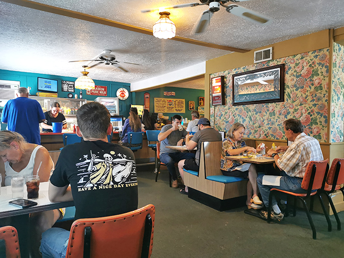 Where strangers become neighbors over eggs and coffee. The ceiling fans keep the conversation flowing as freely as the refills.