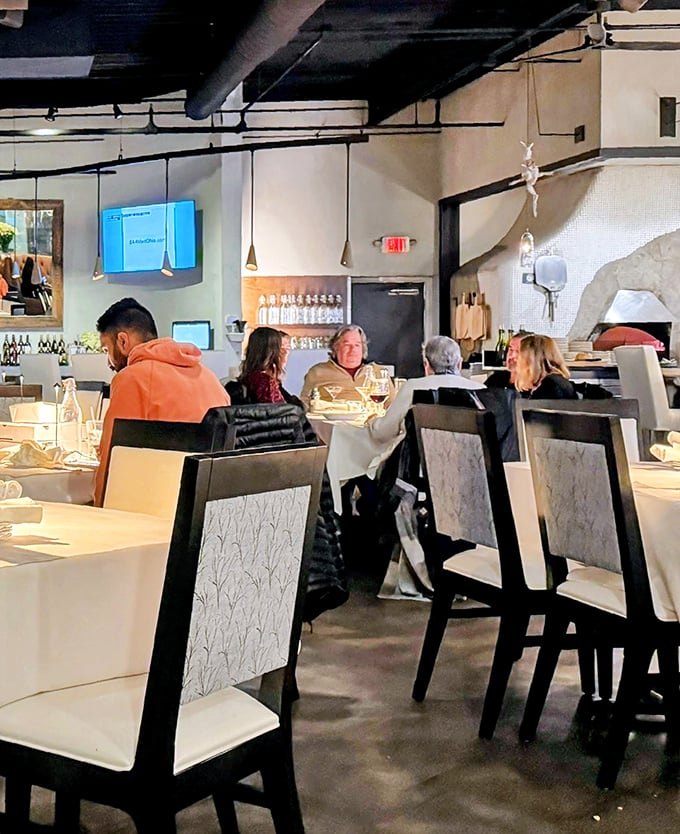 The dining room hums with the universal language of good food, where strangers become united in the pursuit of the perfect bite.