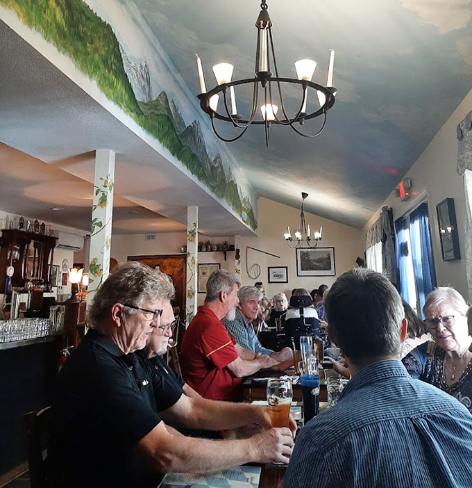 The dining room buzzes with conversation and clinking steins under a ceiling painted to mimic the Bavarian sky&mdash;no passport required.