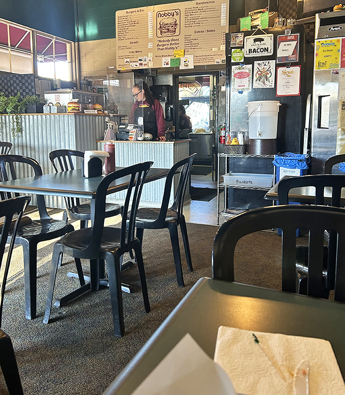 Where burger magic happens. Simple tables, no-nonsense chairs, and the anticipation of something extraordinary coming from that humble kitchen.
