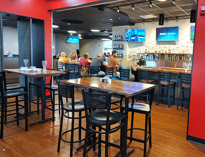 High-top tables and a well-stocked bar create that convivial atmosphere where strangers become friends over shared appreciation of good drinks and better conversation.