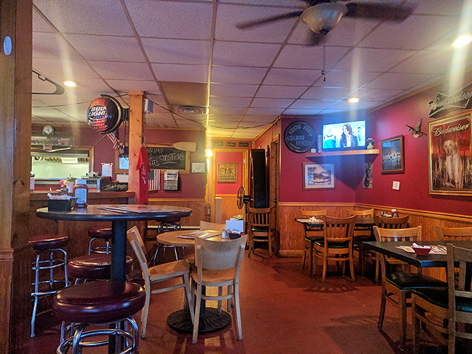 The dining area blends rustic charm with hometown comfort &ndash; red walls, wooden accents, and the promise of conversations worth overhearing. 