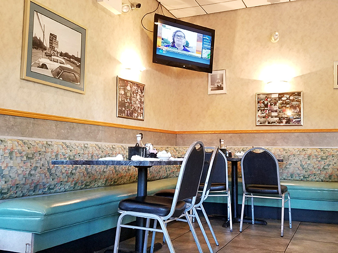 Aqua booths and nostalgic wall photos create the perfect backdrop for coffee conversations that solve all the world's problems by noon.