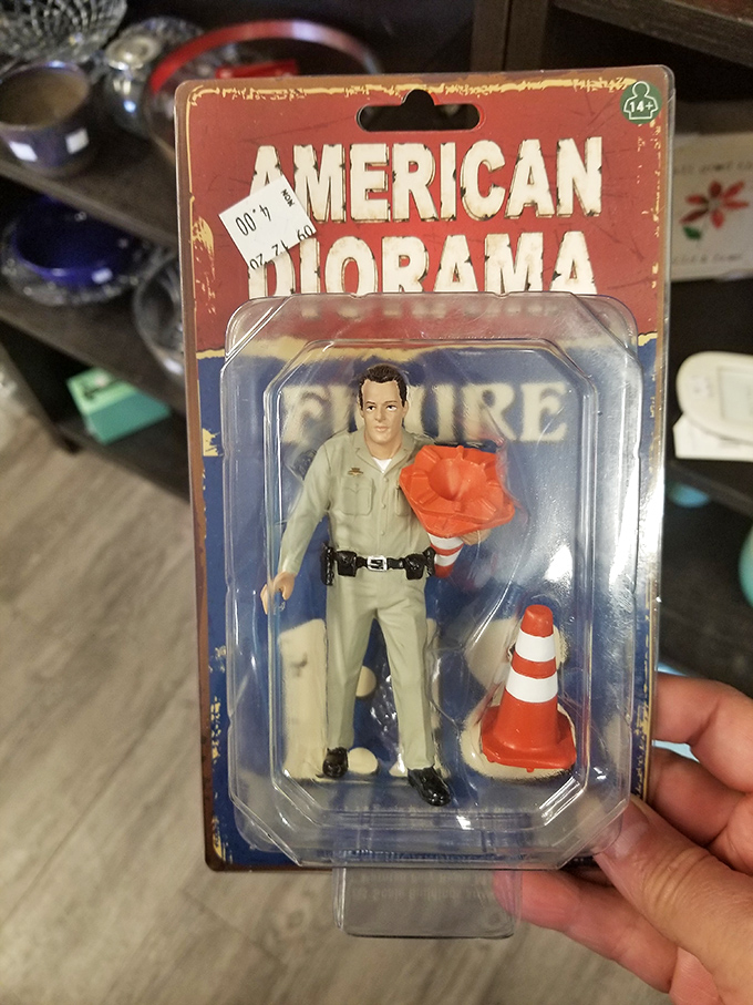 This miniature traffic officer figurine stands ready to direct the flow of nostalgia on your shelf, complete with regulation cone.