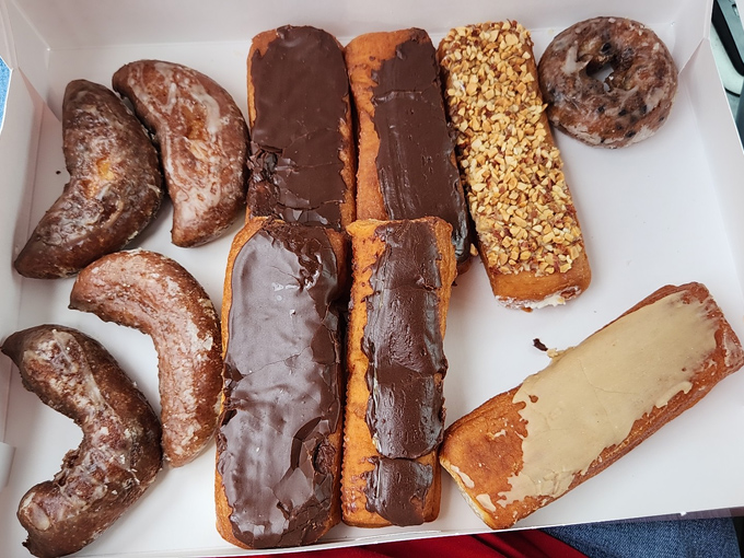 A tasty box of assorted donuts from Crispie Creme, Chillicothe, filled with chocolate-covered treats, nuts, maple, and classic favorites.