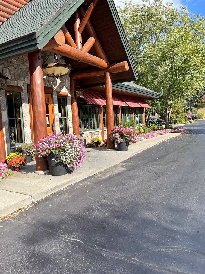 The entrance blooms with Michigan wildflowers, a colorful welcome that softens the lodge's rugged timber and stone fa&ccedil;ade.