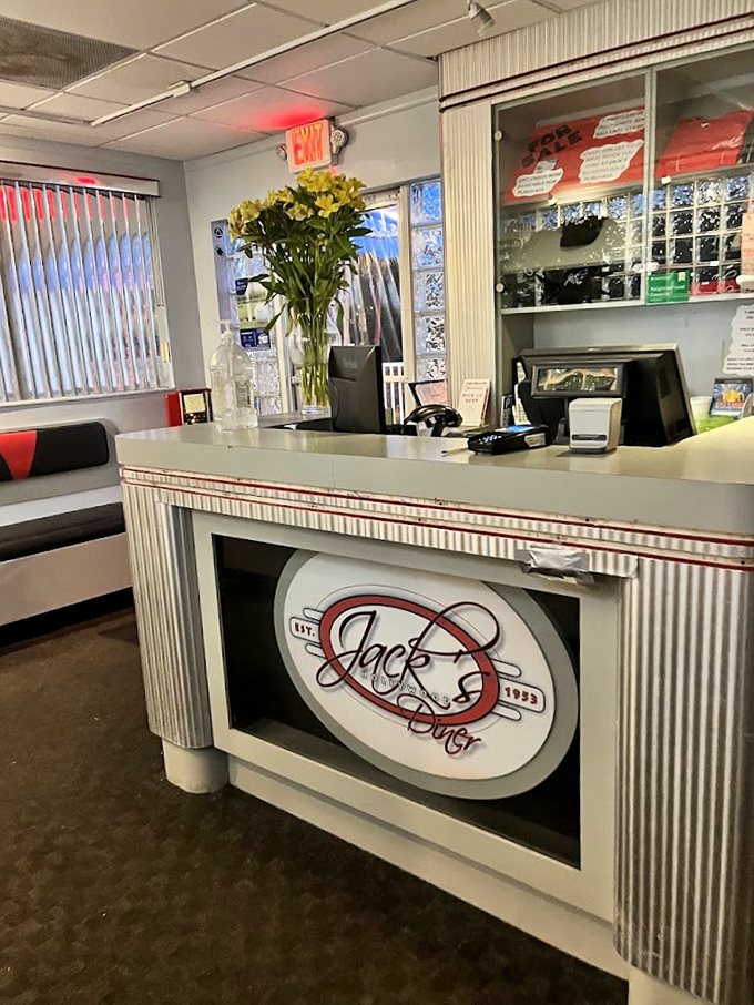 The front desk welcomes you with vintage charm and fresh flowers, setting the tone for the homestyle experience that awaits.