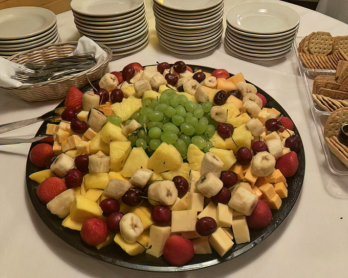 This fruit and cheese platter isn't just appetizing &ndash; it's architectural. The grapes form a verdant dome over a landscape of dairy and fruity delights.