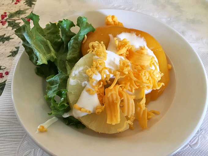 A fruit salad that didn't get the memo about being boring. That shredded cheese is the plot twist nobody saw coming.