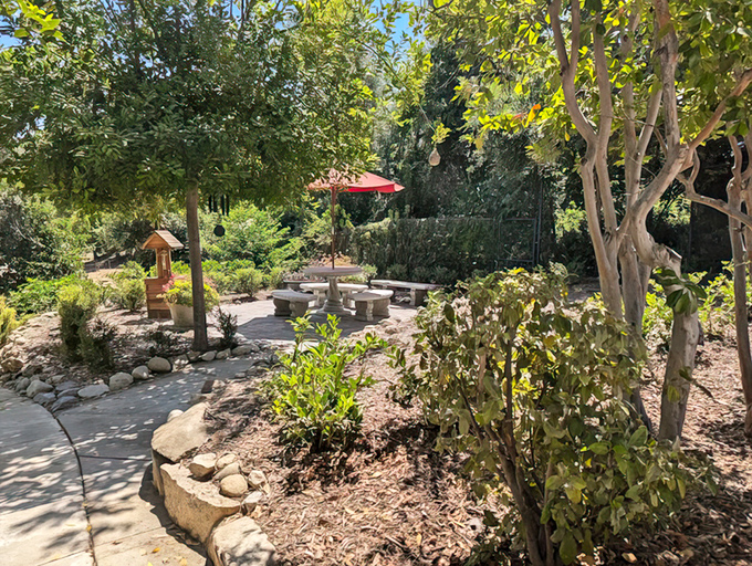 A secret garden nook with stone seating invites visitors to pause and contemplate life's big questions, like "How soon can I move in?"
