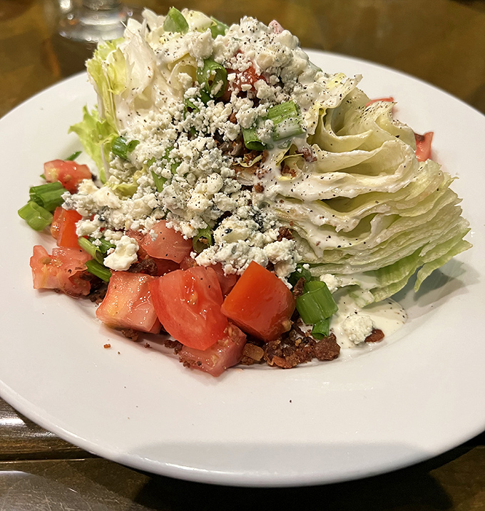 A wedge salad that doesn't know it's supposed to be a supporting character. With blue cheese crumbles and fresh tomatoes, it's staging a delicious coup.