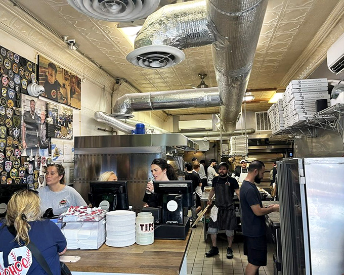 The bustling interior reveals the organized chaos of a beloved institution, where every sandwich is assembled with practiced hands.