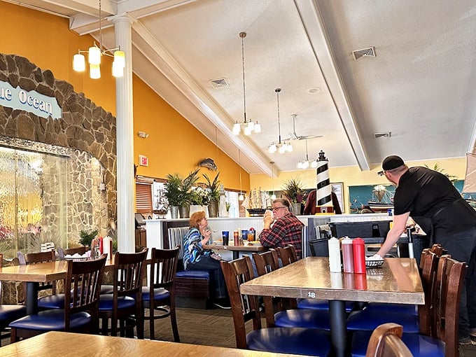 Warm yellow walls and maritime d&eacute;cor create that "come as you are, leave fuller than you planned" atmosphere locals adore.