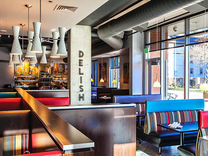 Colorful booths pop against industrial elements&mdash;proof that brunch spots, like the best breakfast plates, balance comfort with just enough excitement.