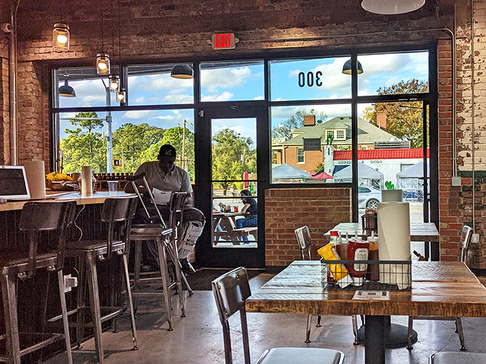 Natural light floods through large windows, illuminating a space where barbecue tradition meets contemporary design in perfect harmony.