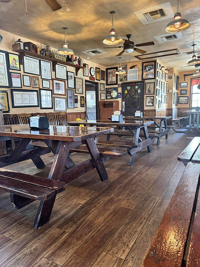 Picnic tables that have witnessed more food euphoria than a cooking show audience. The wall of fame tells stories of barbecue glory.