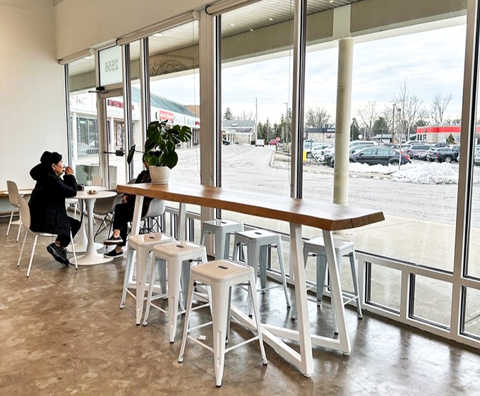 Winter outside, warmth inside. The floor-to-ceiling windows create the perfect backdrop for contemplating life's big questions over small pastries.