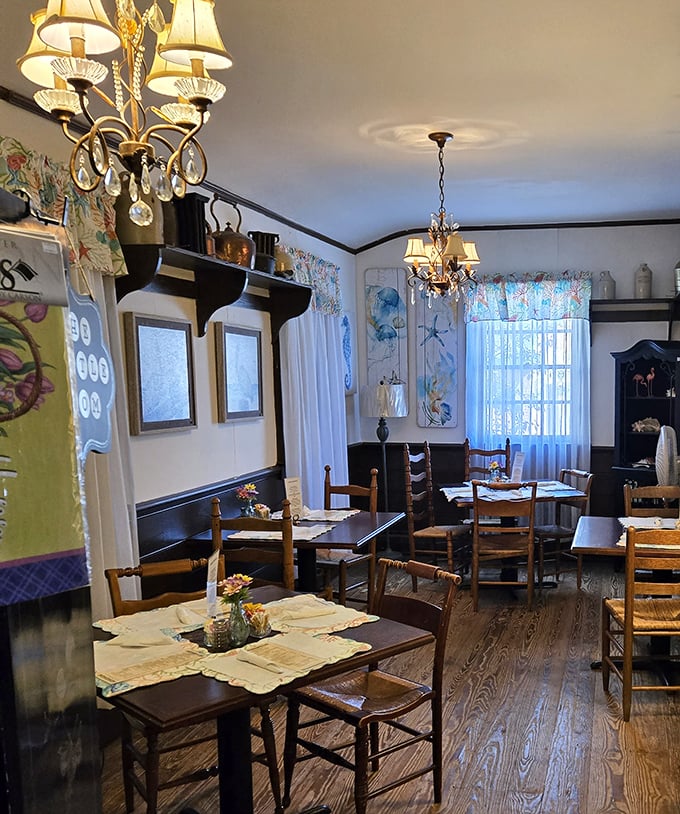 Chandeliers cast a gentle glow over wooden tables while floral curtains flutter in the breeze&mdash;Southern charm without trying too hard.