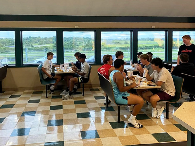 Young athletes fueling up after practice – creating memories that will last longer than their teenage appetites. Future regulars in training.