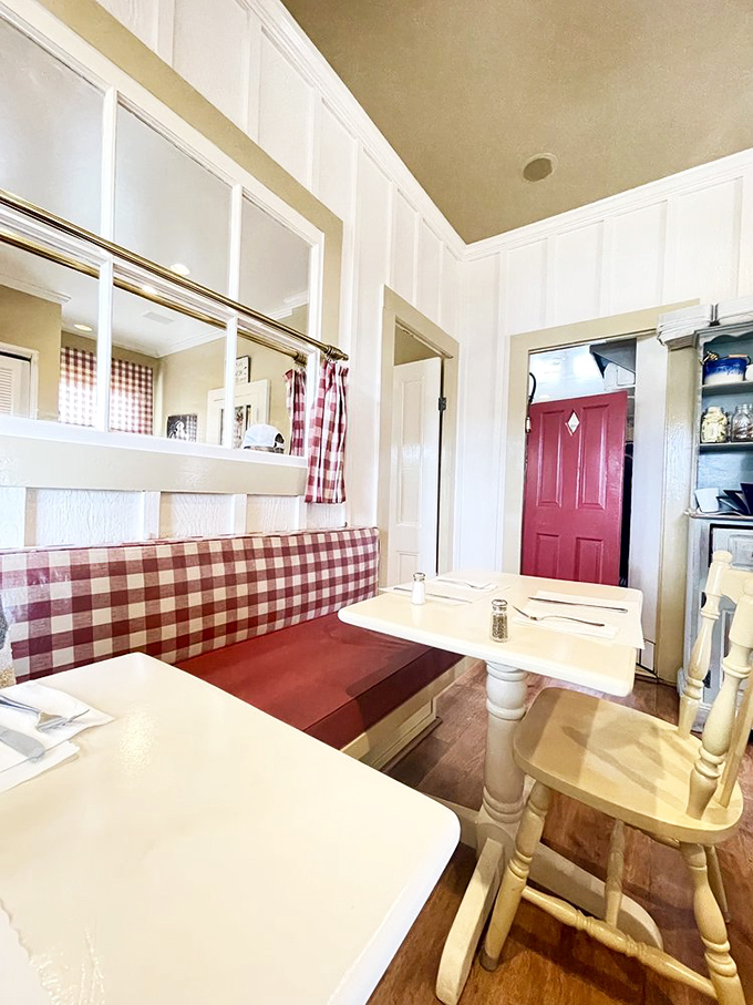 Red-checkered banquettes and cream-colored tables create dining nooks that feel like you're eating in someone's cherished country kitchen.